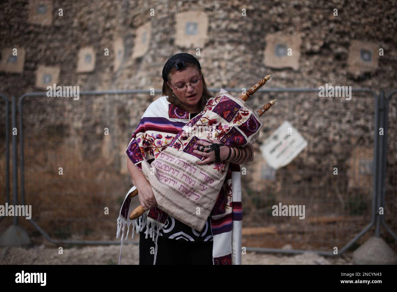 An Israeli woman of the Women of the Wall organization wears tefillin ...