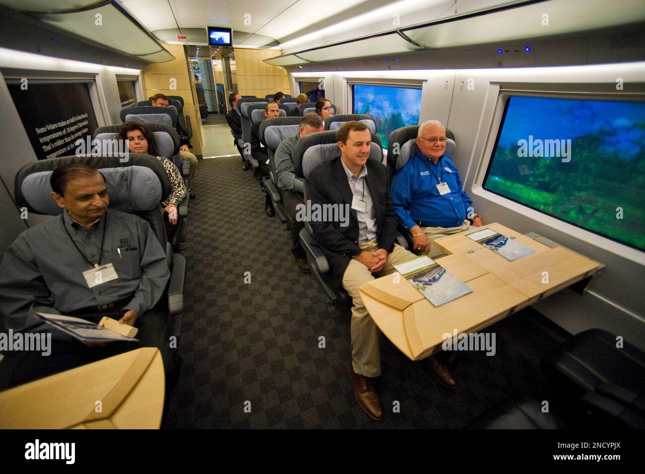 Guests visit a mock-up of a high speed rail train exhibit at the Museum ...