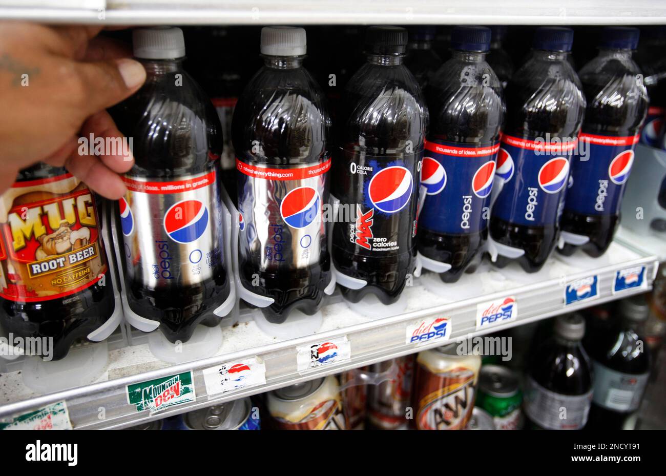 Customer reaches for a Pepsico product Pepsi at a grocery store in Palo ...