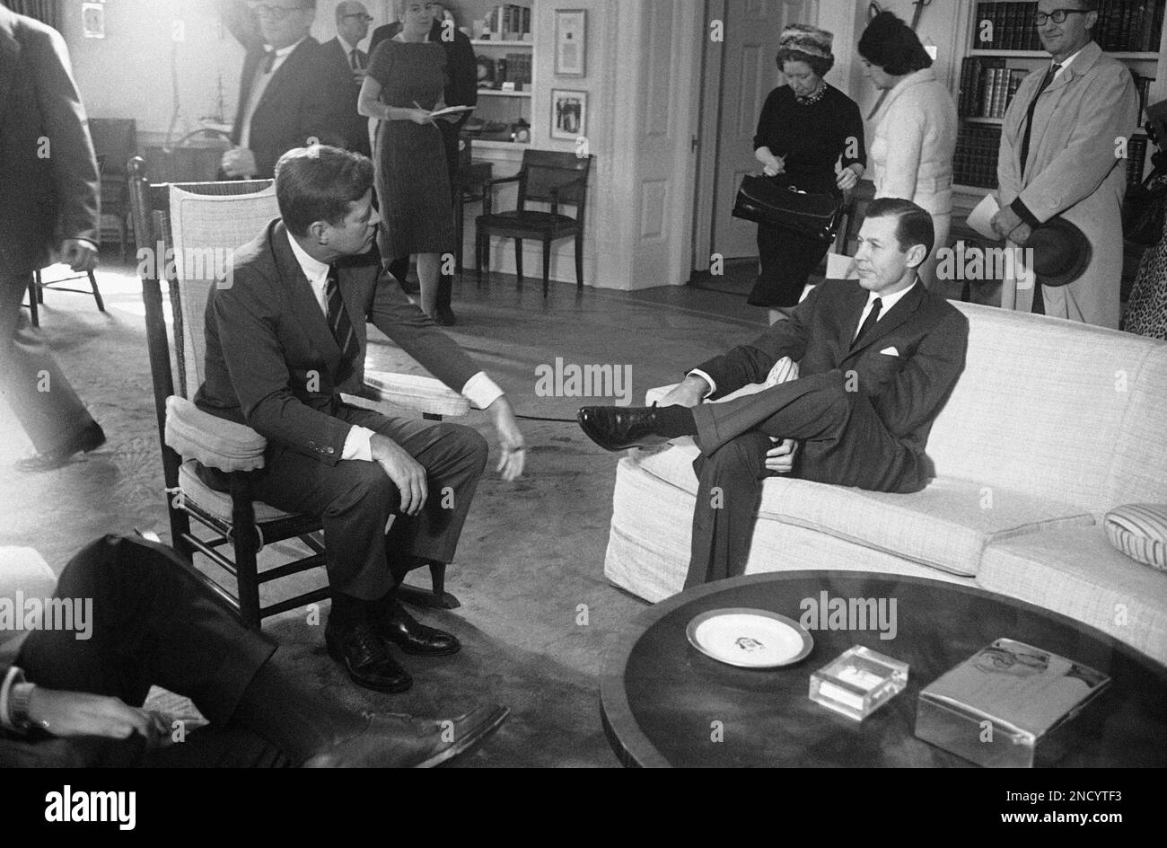 President John Kennedy leans forward in his rocking chair as he chats ...