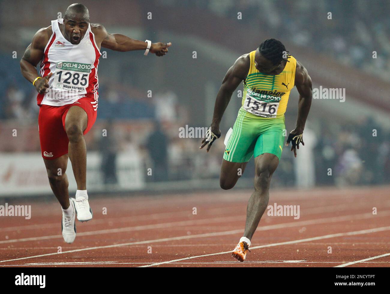 Jamaica's Lerone Clarke, right, crosses the finish line ahead of ...
