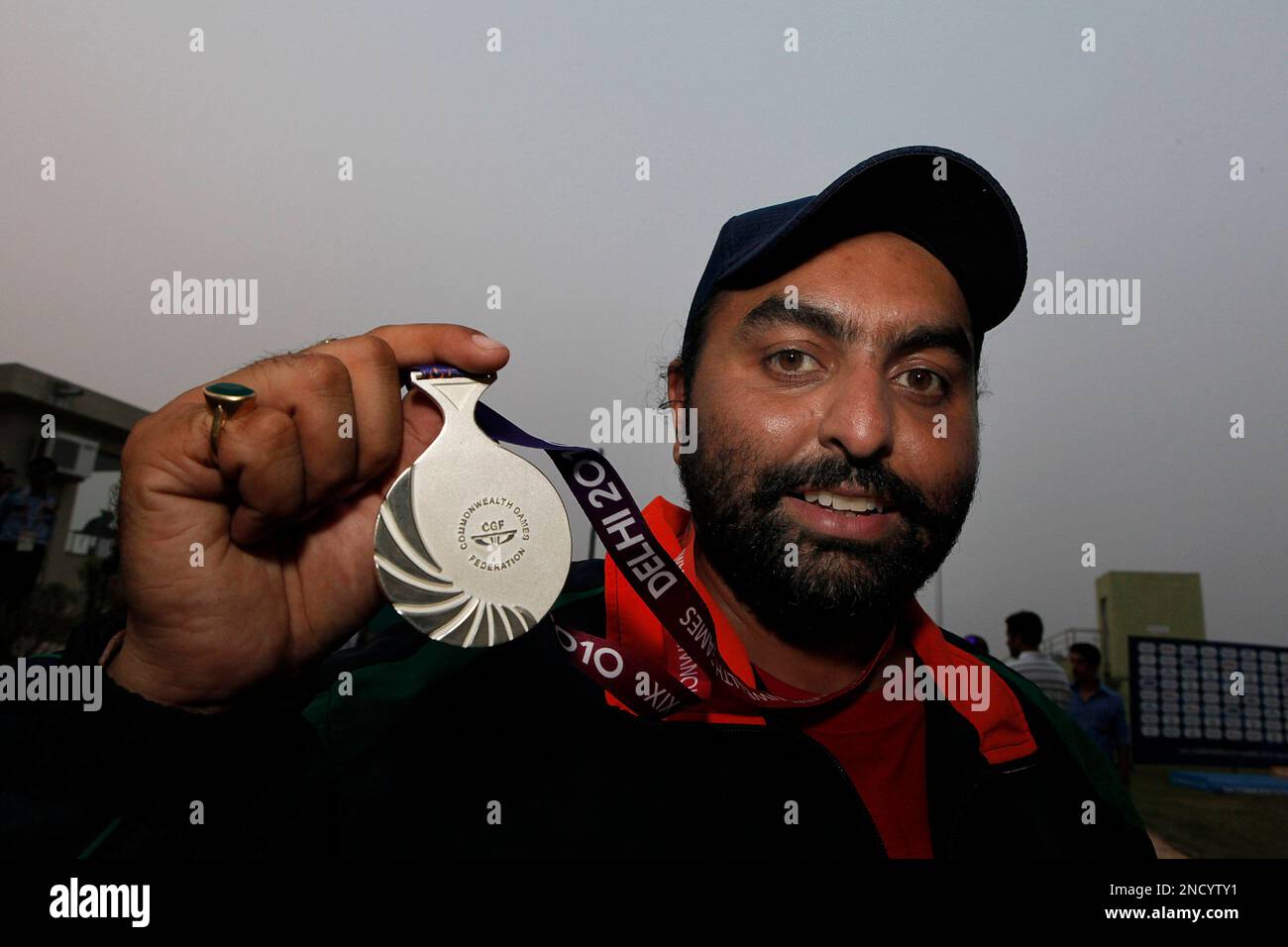 India's Ronjan Sodhi displays his silver medal during the medal ...