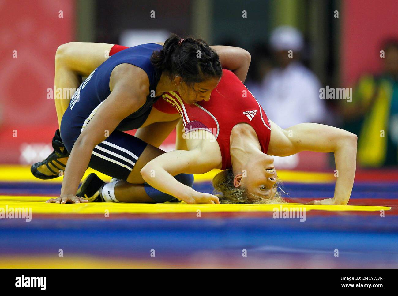 India's Geeta, in blue, wrestles for the gold with Australia's Emily ...