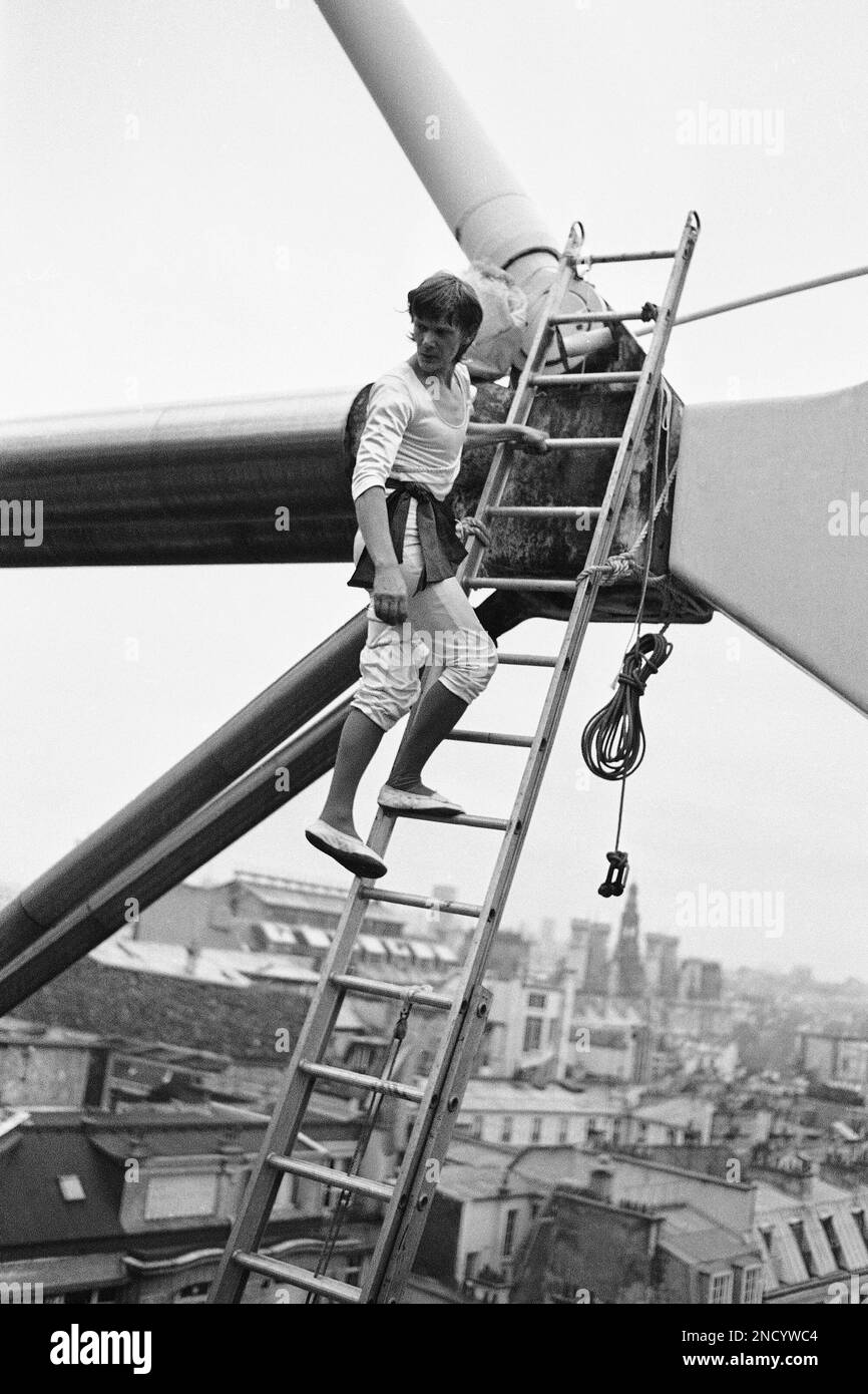 French tightrope walker Philippe Petit on a ladder high above Paris ...