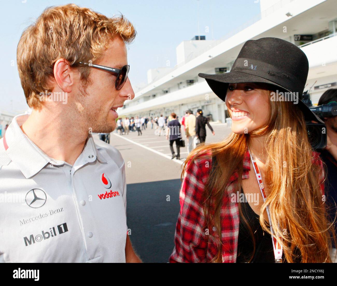 McLaren Formula One driver Jenson Button of Britain walks with his ...