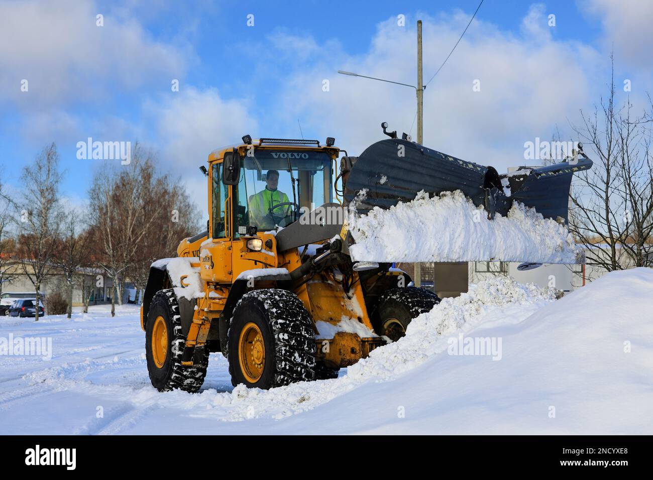 Removing snow with Volvo L70E wheel loader equipped with snowplough ...