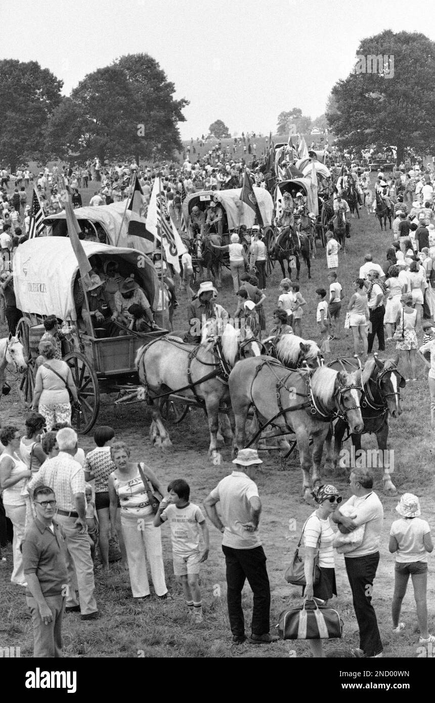 Flags wave from the covered wagons of the Bicentennial Wagon Train upon ...