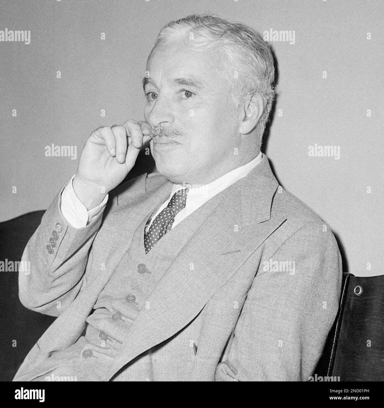 Charles Chaplin twists his new mustache, grown for his next movie role ...
