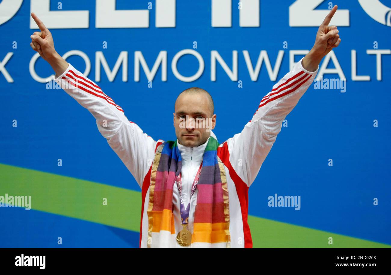 England's James Goddard poses with his gold medal on the podium ...