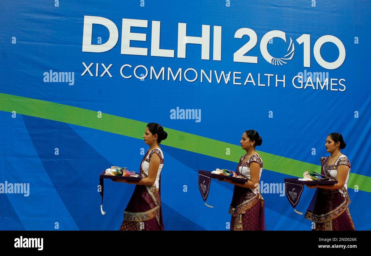Indian hostesses carry the medals to the ceremony fot the 200 m ...