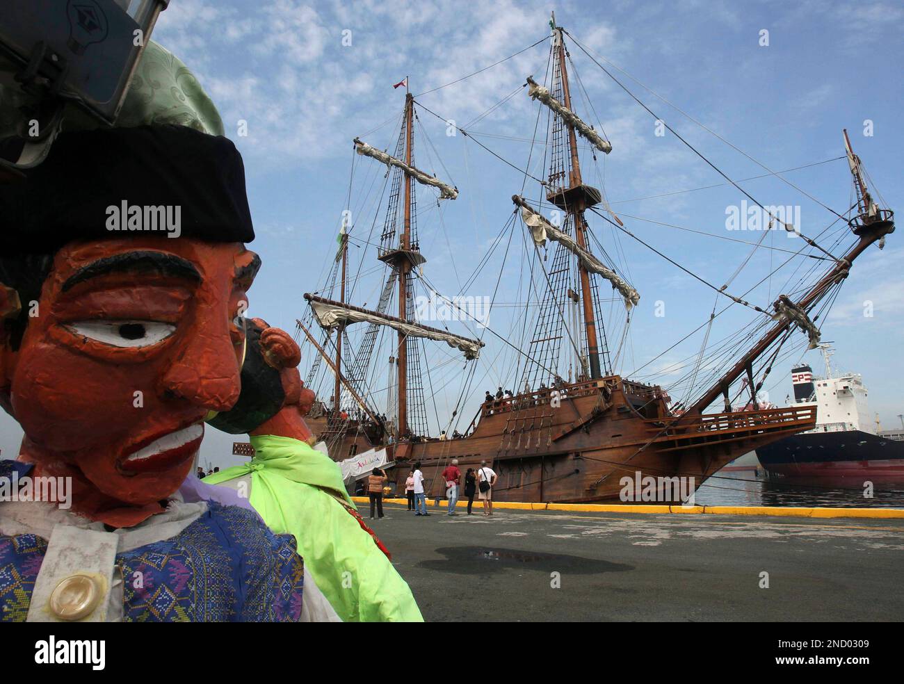 Giant paper mache props known as "Higantes", left, are placed near the ...