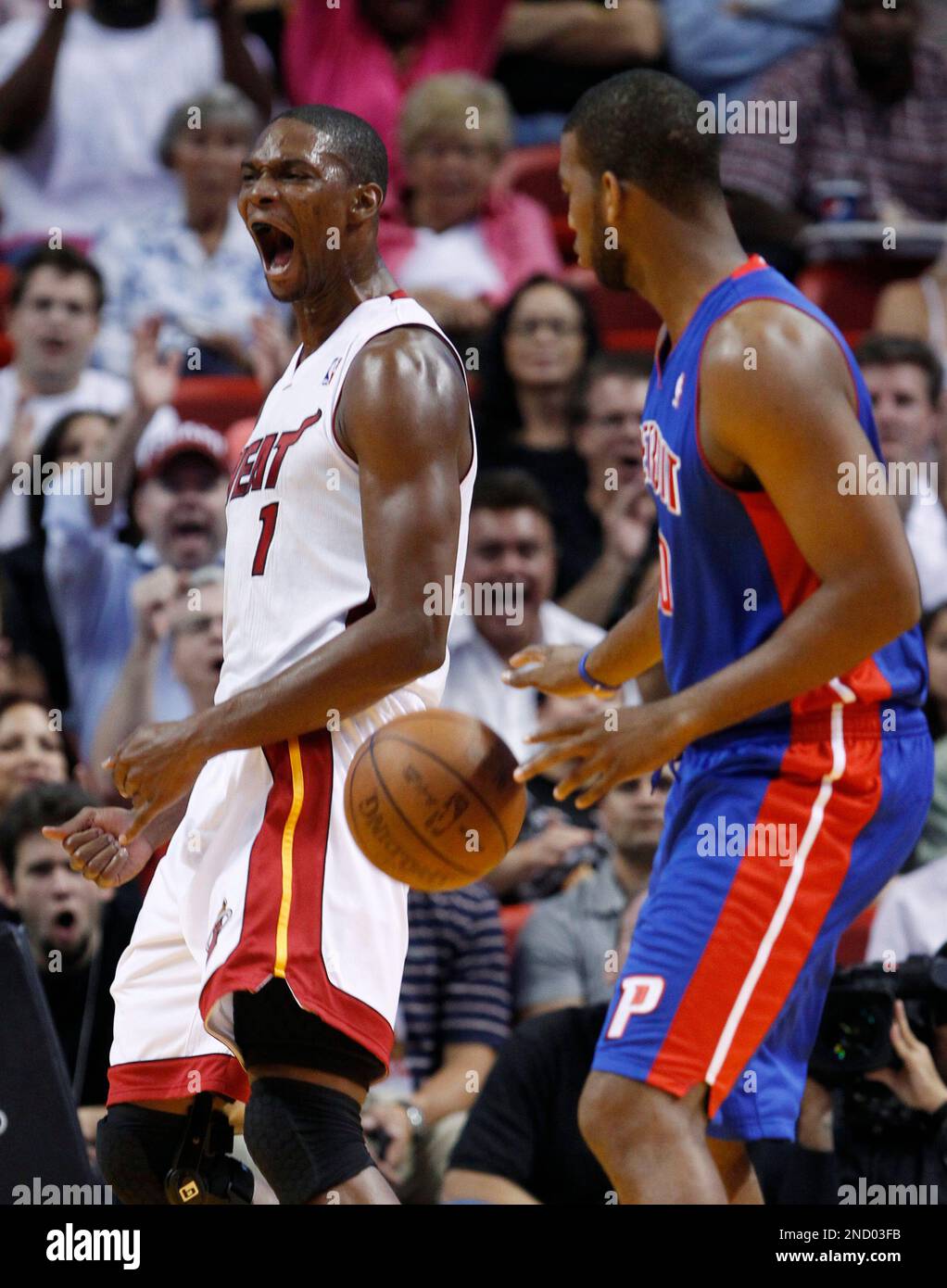 Miami Heat forward Chris Bosh (1) reacts after dunking the ball as ...