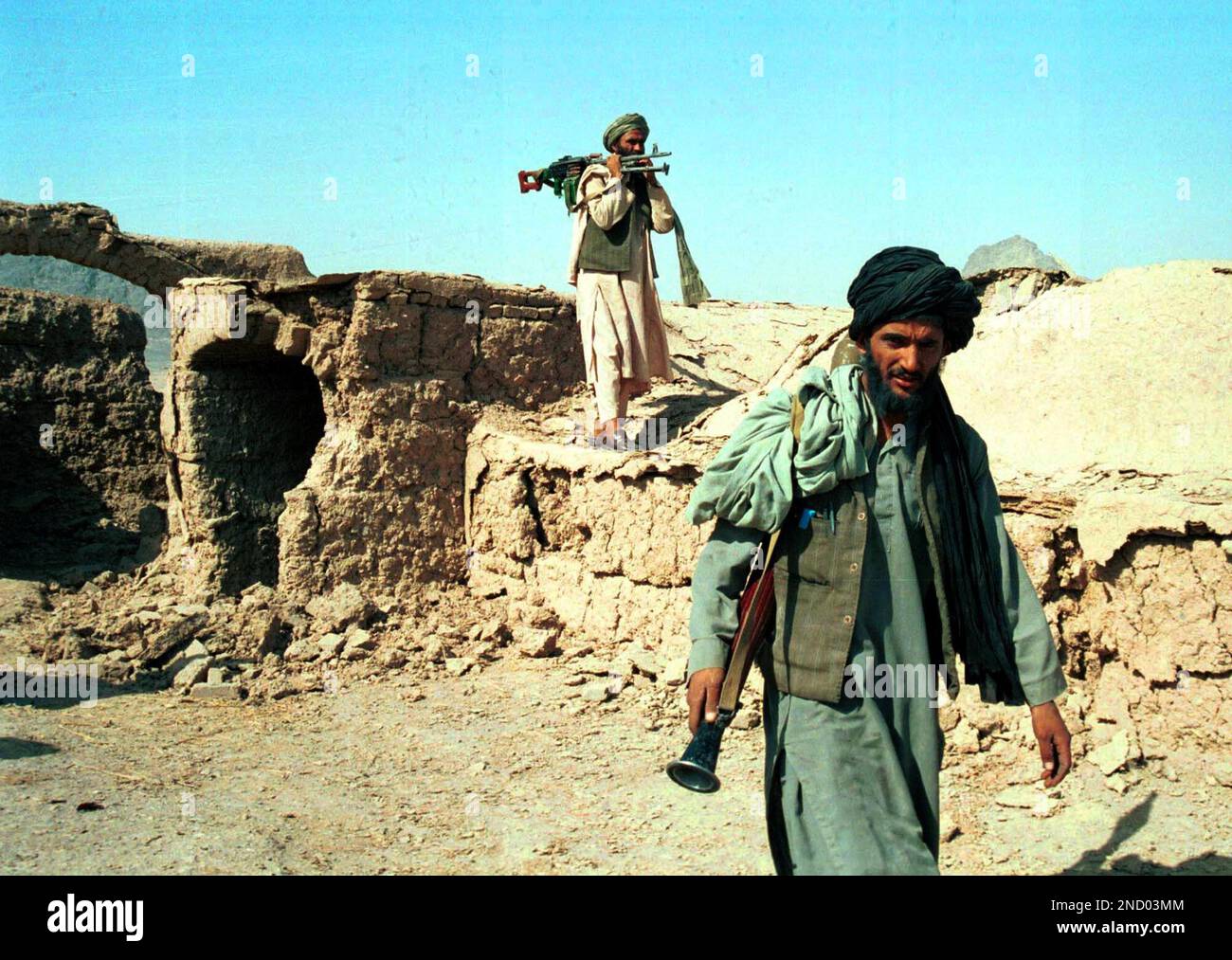FILE - In this Friday Nov. 2, 2001 file picture, Taliban fighters, one ...