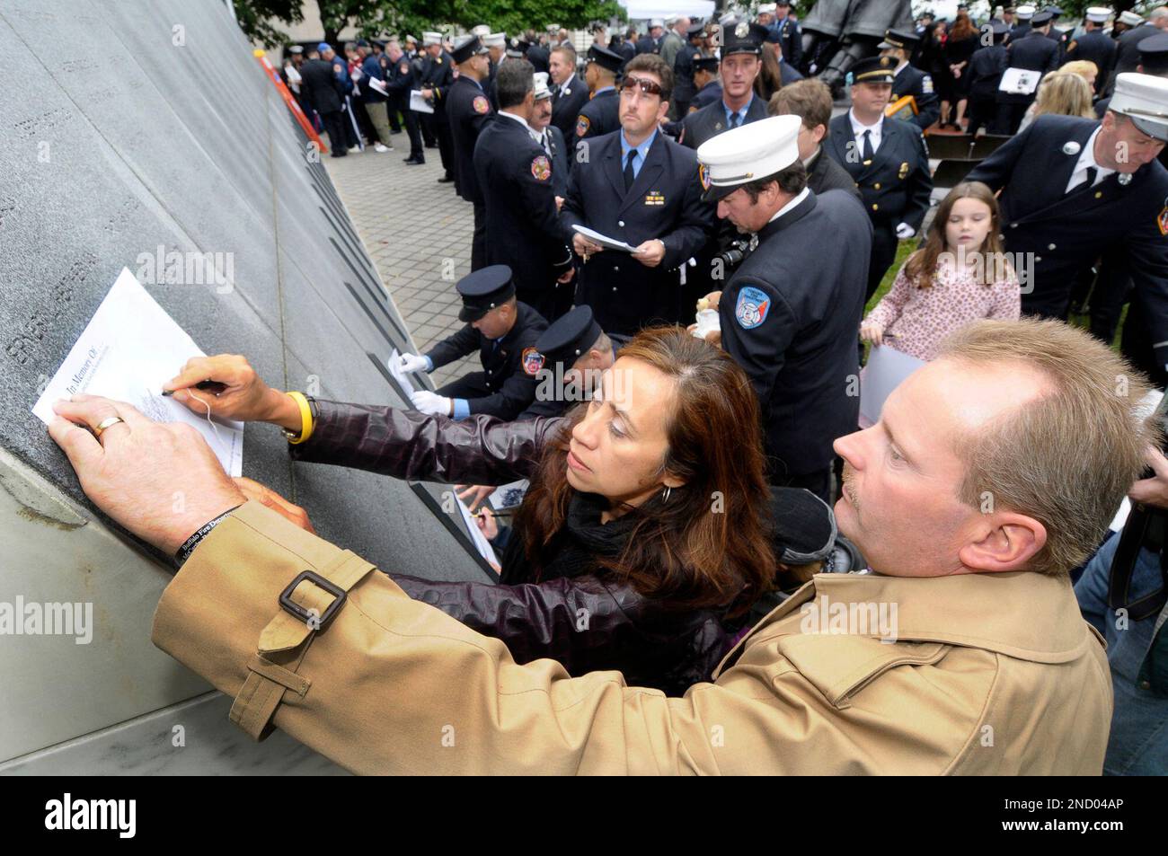 Angie Heusinger and her husband Duane Heusinger do a rubbing of her ...
