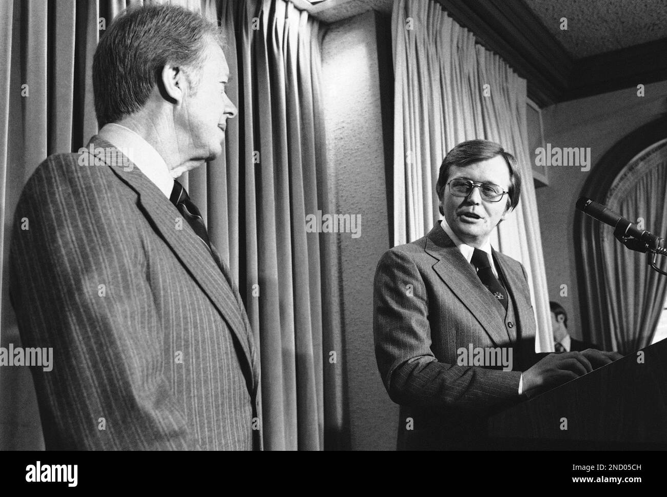 President Jimmy Carter stands nearby as James T. McIntyre faces ...