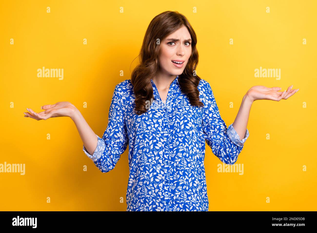 Photo of shocked puzzled lady wear print shirt rising arms shrugging ...