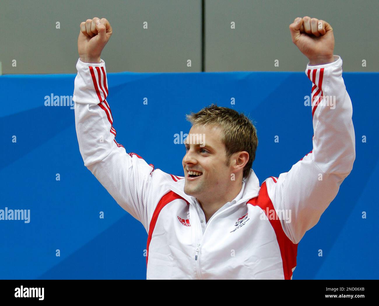 England's Liam Tancock celebrates on the podium before receiving his ...