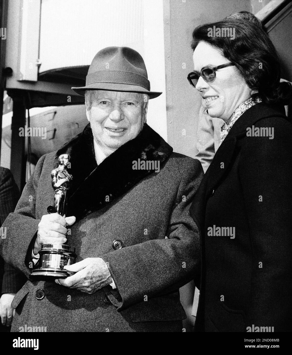 Charlie Chaplin, with his wife Oona, on arrival at Heathrow airport ...