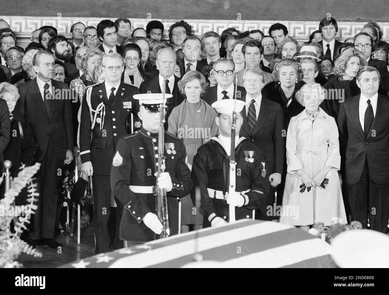 Members of the honor guard stand beside the casket containing the ...