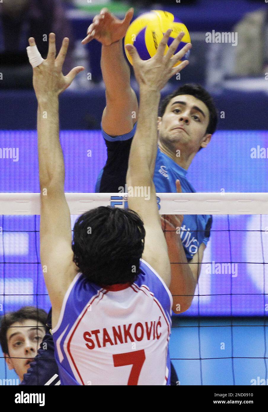 Argentina's Sebastian Sole spikes the ball against Serbia 's Dragan ...