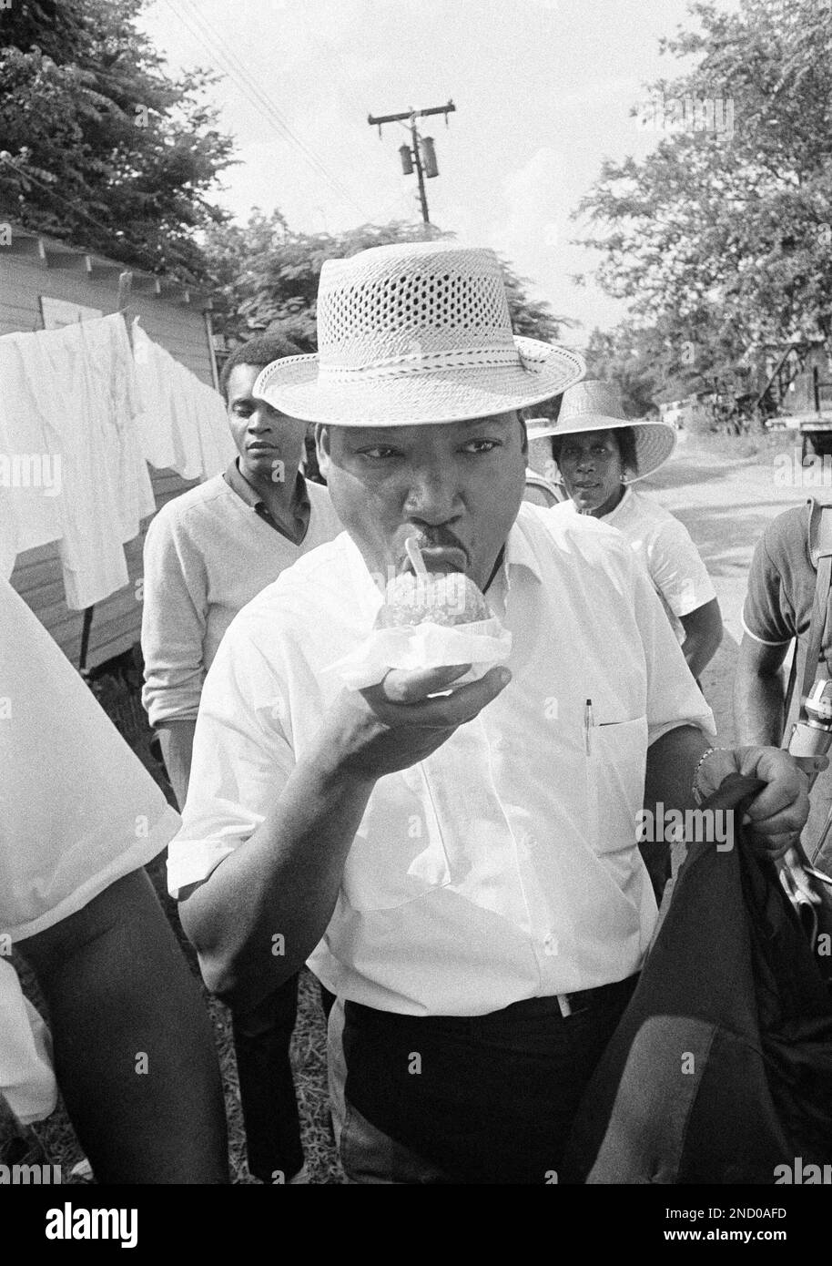 Dr. Martin Luther King, to lead the Meredith March, bites into a ...