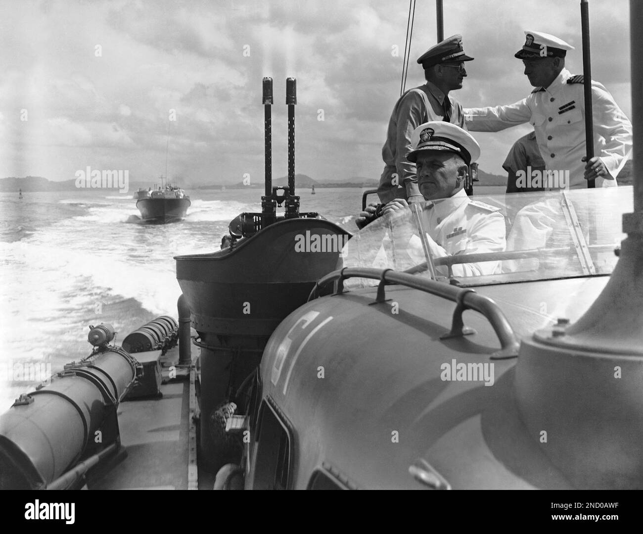 Rear Admiral Clifford Evans Van Hook, 15th Naval district commandant, foreground, is aboard a PT ...