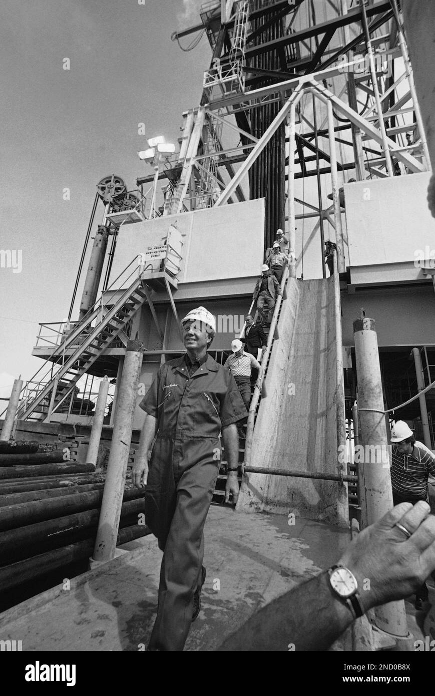 President Jimmy Carter wears a jumpsuit and a hardhat as he inspects ...
