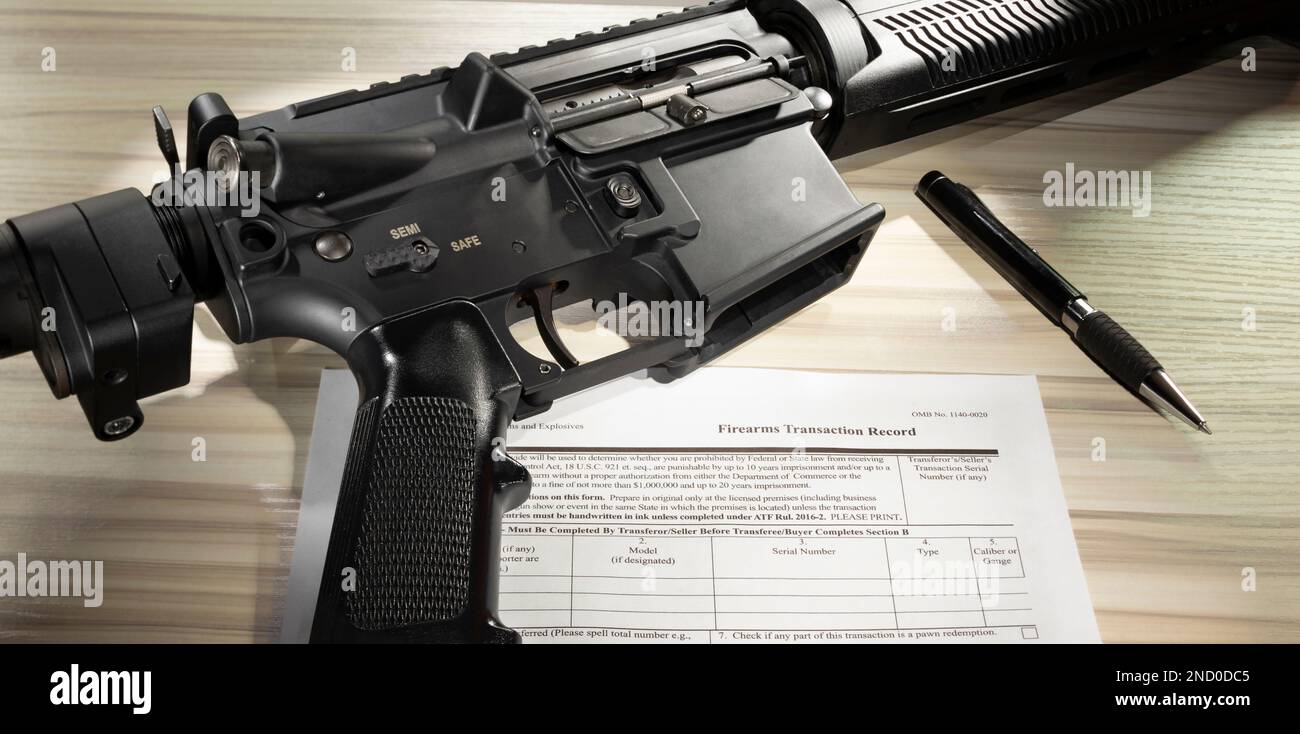 Assault rifle with background check form for its purchase Stock Photo ...
