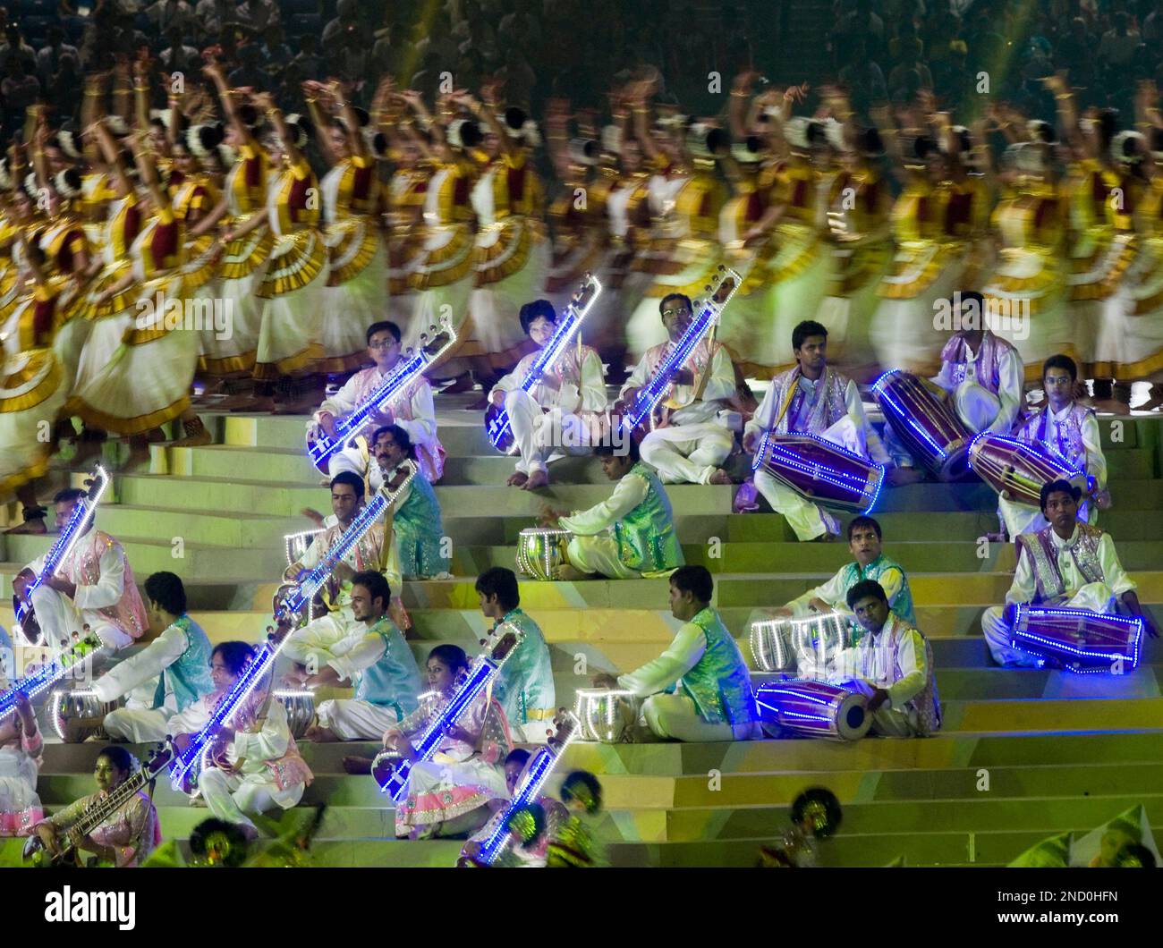 Dancers and musicians perform at Jawaharal Nehru Stadium during opening ...