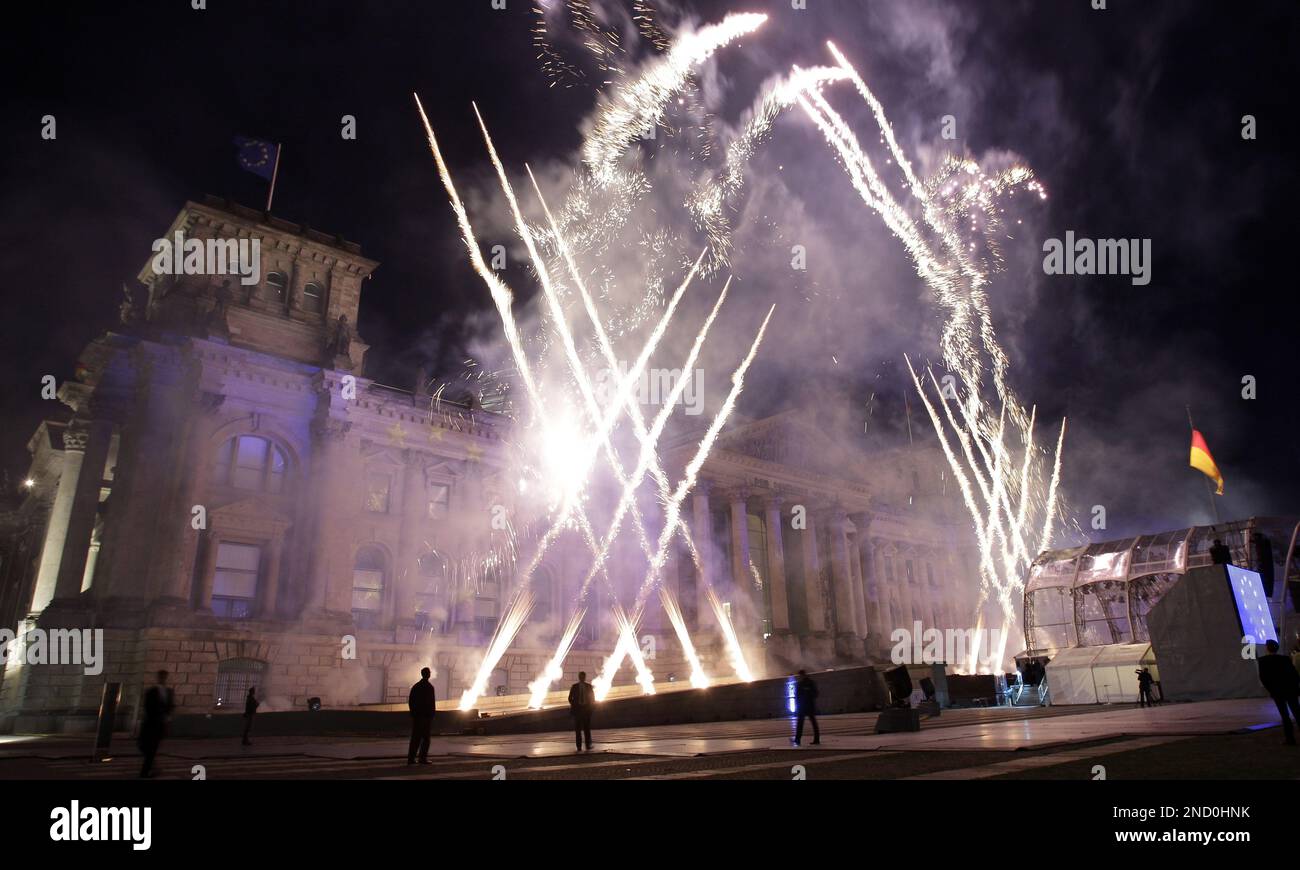 Fireworks explode at the front of the Reichstag Building during a ...
