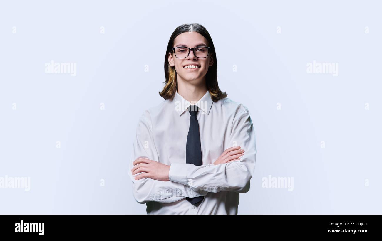 Portrait of confident young male student on white studio background ...