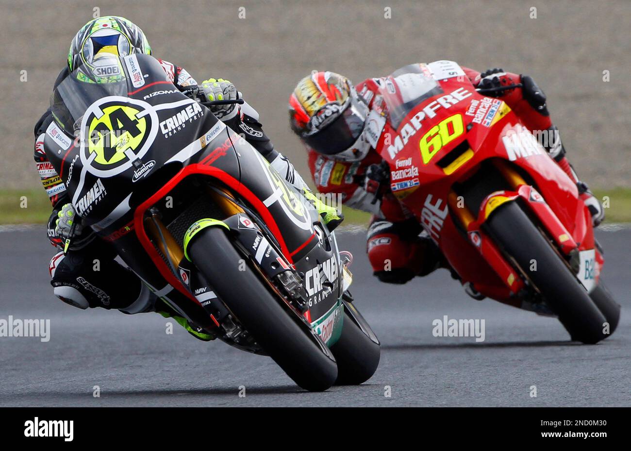 Spanish Moto2 rider Toni Elias, tailed by Spanish Julian Simon on Suter ...