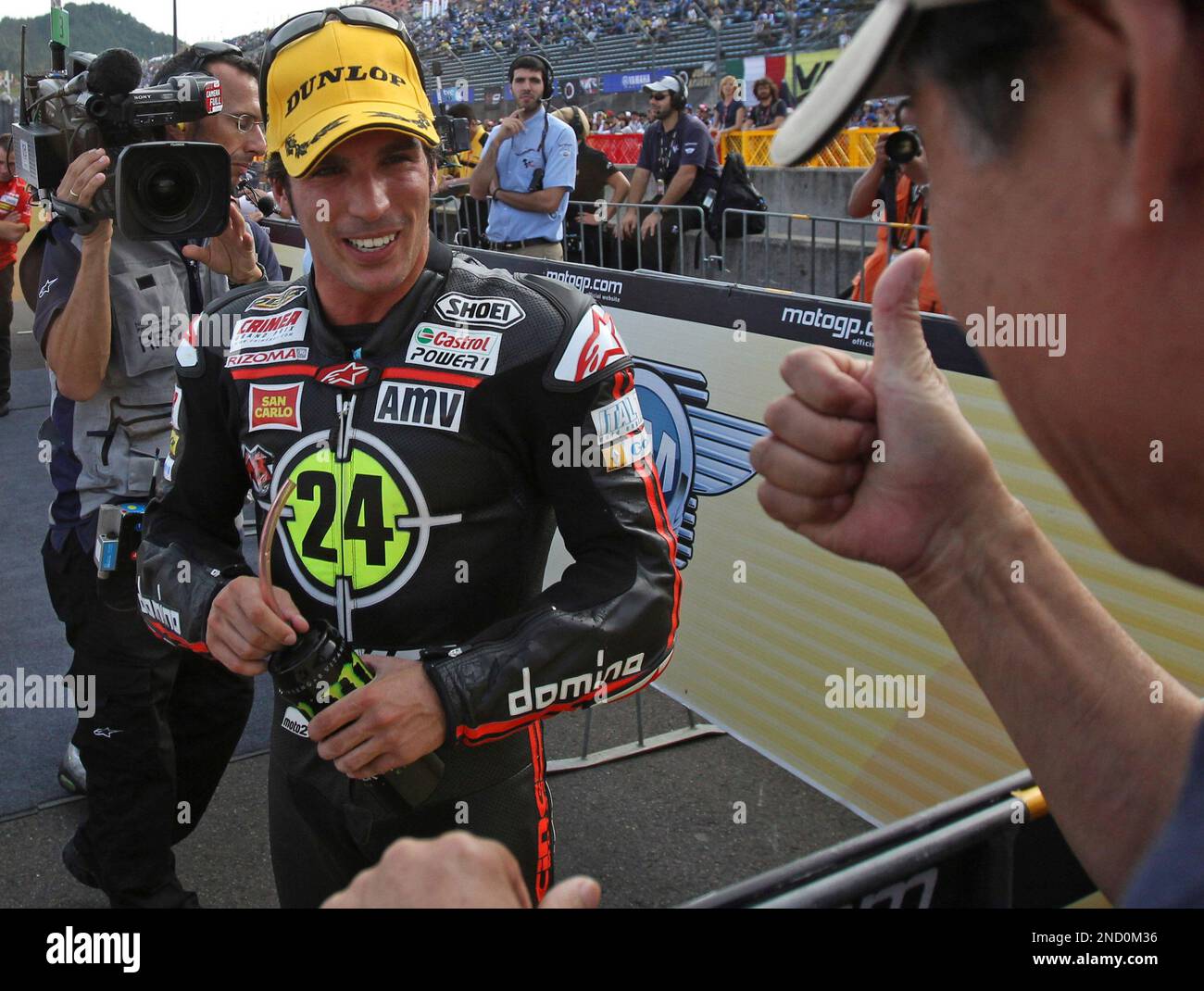 Spain's Moto2 rider Toni Elias smiles at a supporter after winning the ...