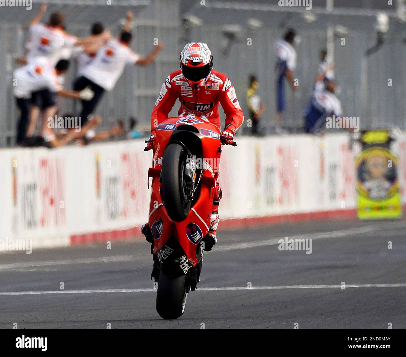 MotoGP Ducati rider Casey Stoner of Australia does wheelie as he ...