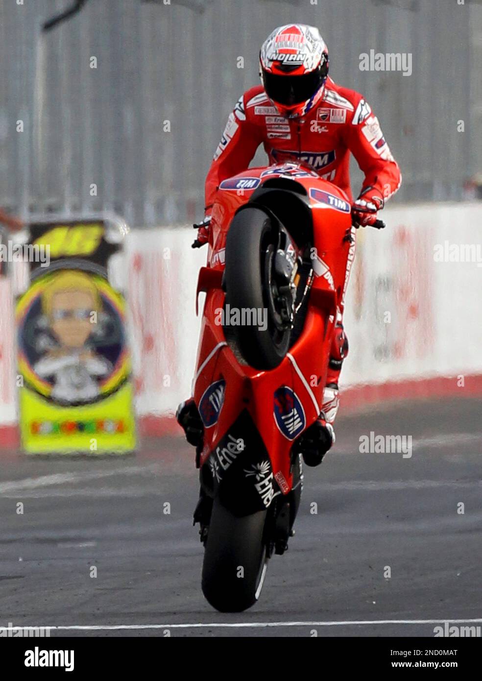 MotoGP Ducati rider Casey Stoner of Australia does wheelie as he ...