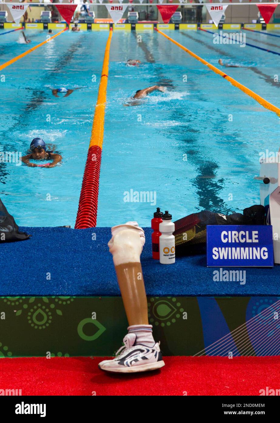 An artificial limb sits at the edge of the pool during a practice ...