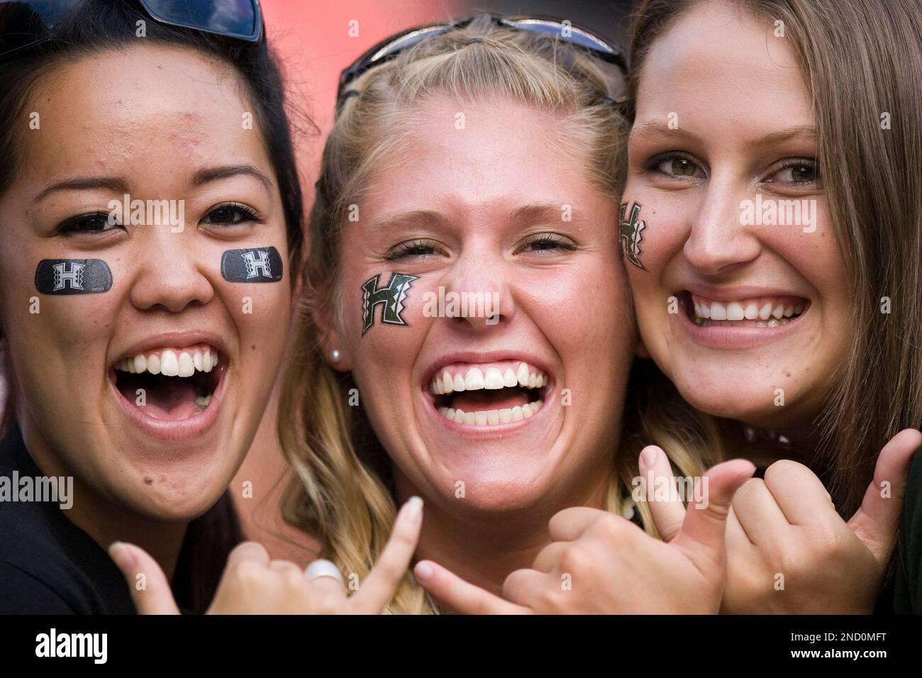 Hawaii fans Ui Tanigawa, left, Emmie Yeiter, center, and Jessica Wack ...