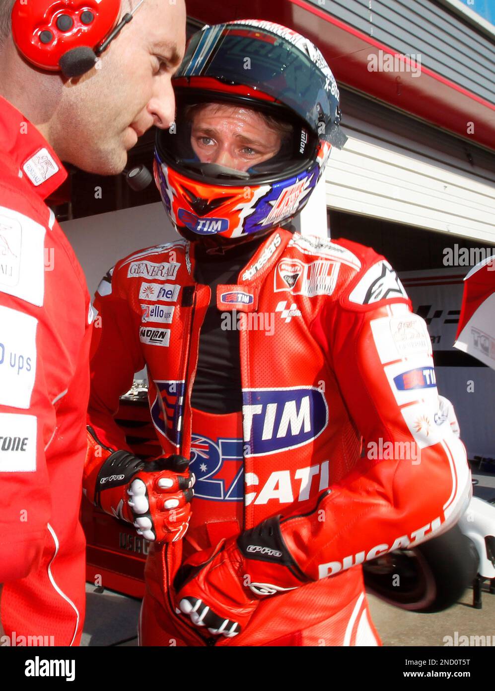 Australia's Casey Stoner talks with his team staff during the ...