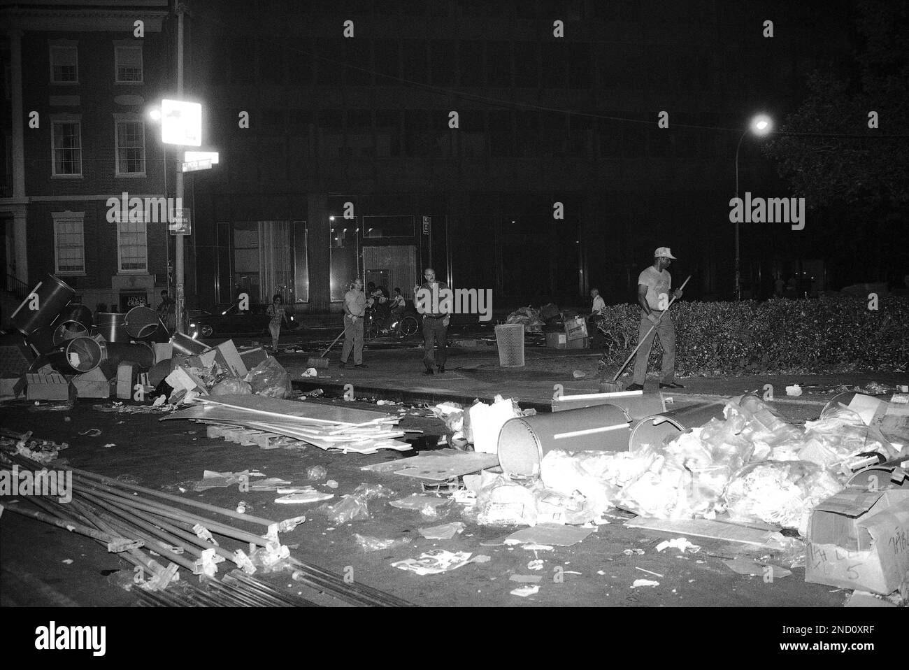 New York sanitation workers use a bulldozer to move a mountain of ...