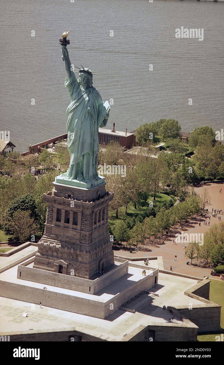 Statue of Liberty with Ellis Island in background in New York on June ...