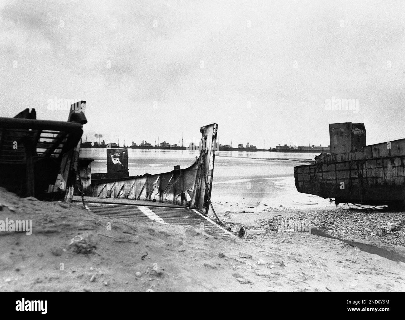 Wrecked assault craft half buried in the sand on Omaha beach, reminders ...
