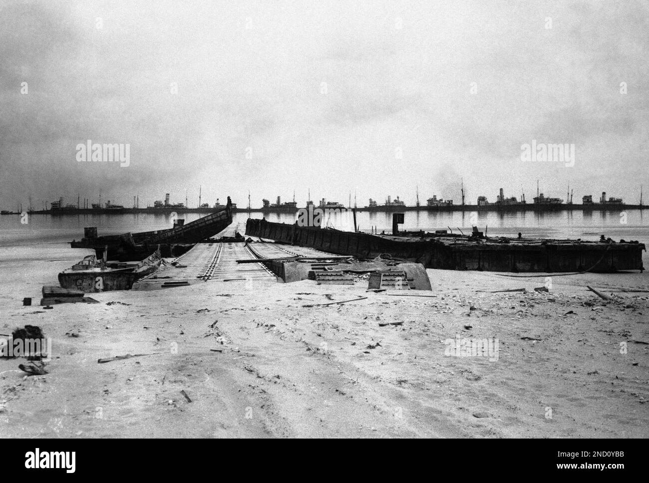 Wrecked portable dock with sunken ships acting as a breakwater to form ...