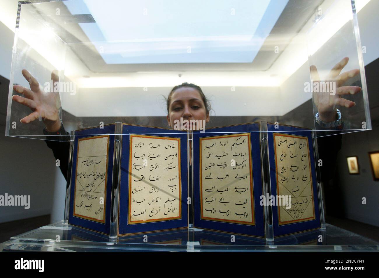 A Sotheby's employee replaces the display case cover on a 1276 AH/1859 ...