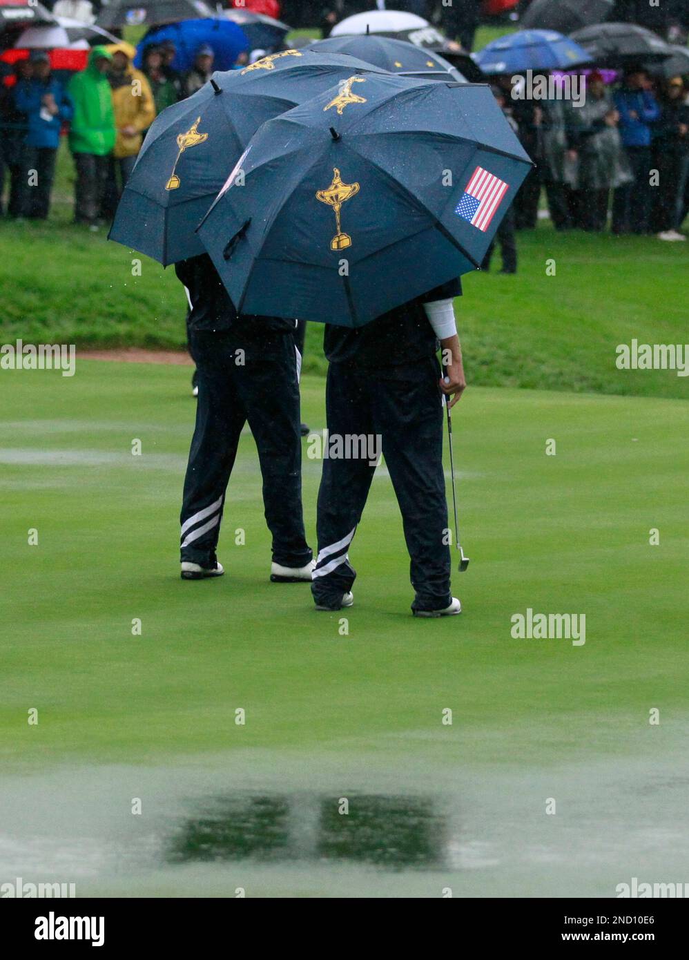 U.S. team members Phil Mickelson and Dustin Johnson stand under their ...