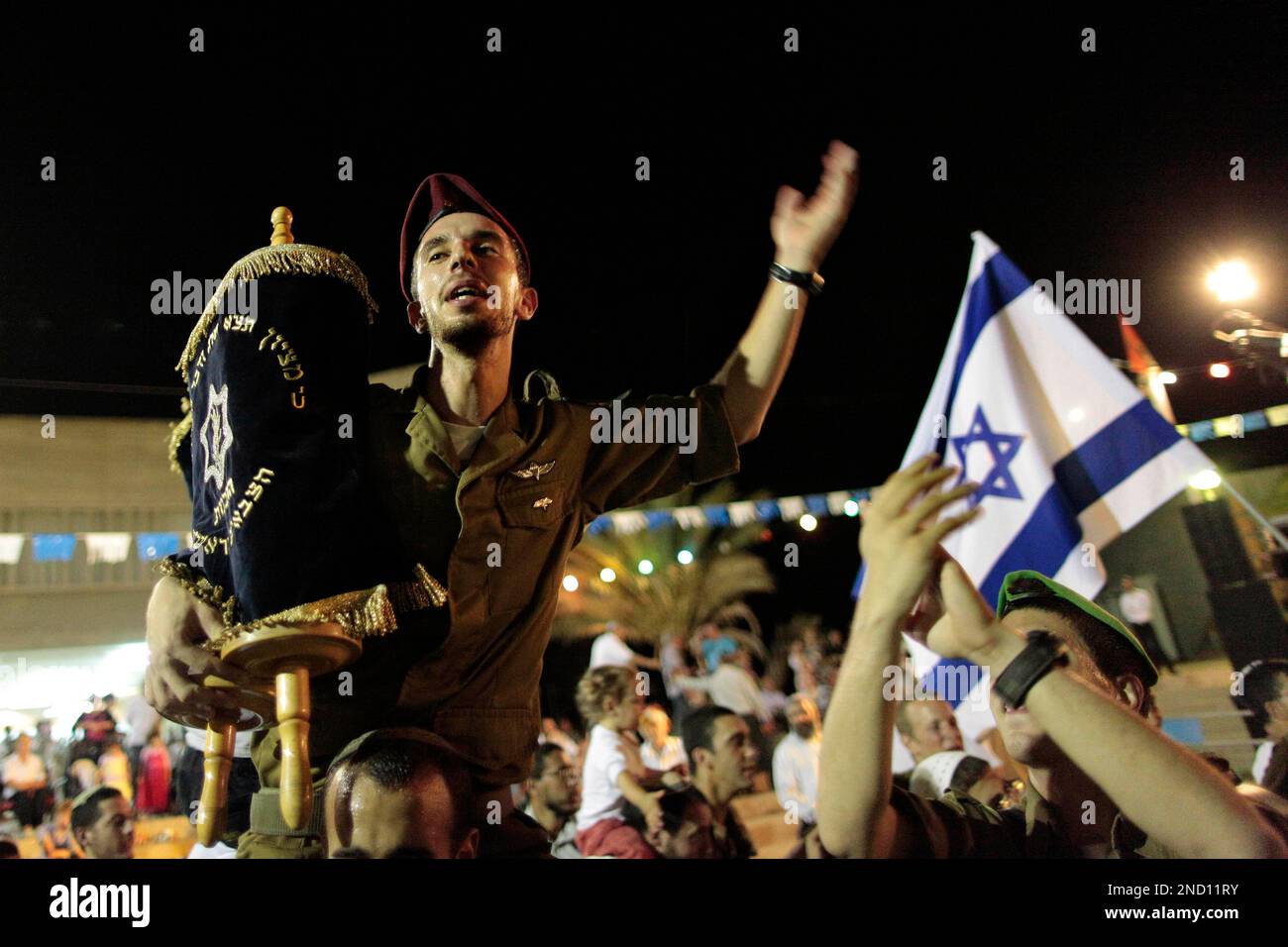 Israelis soldiers carry a Torah Scroll as they dance with others during ...