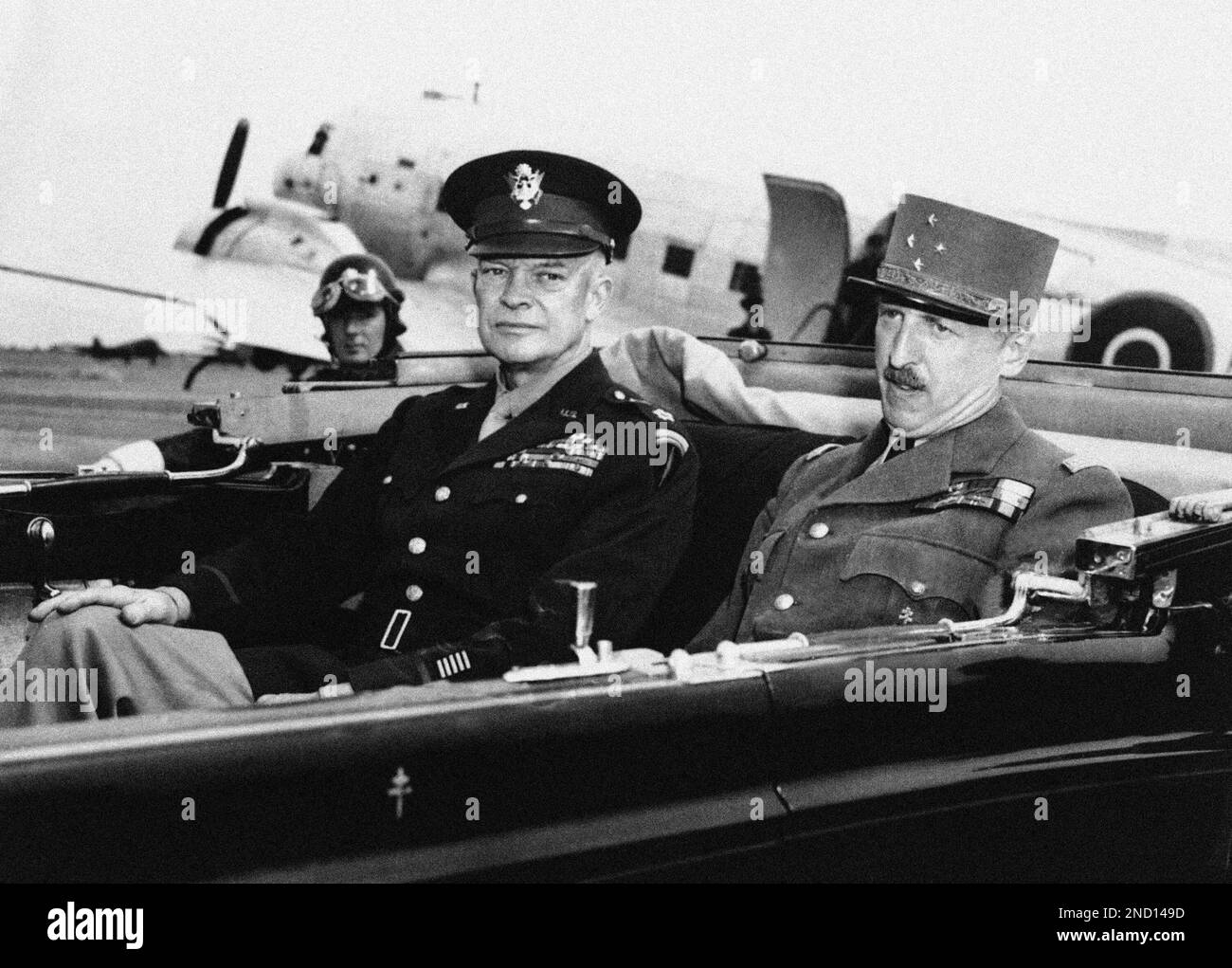 General Dwight Eisenhower drives from the airport accompanied by ...