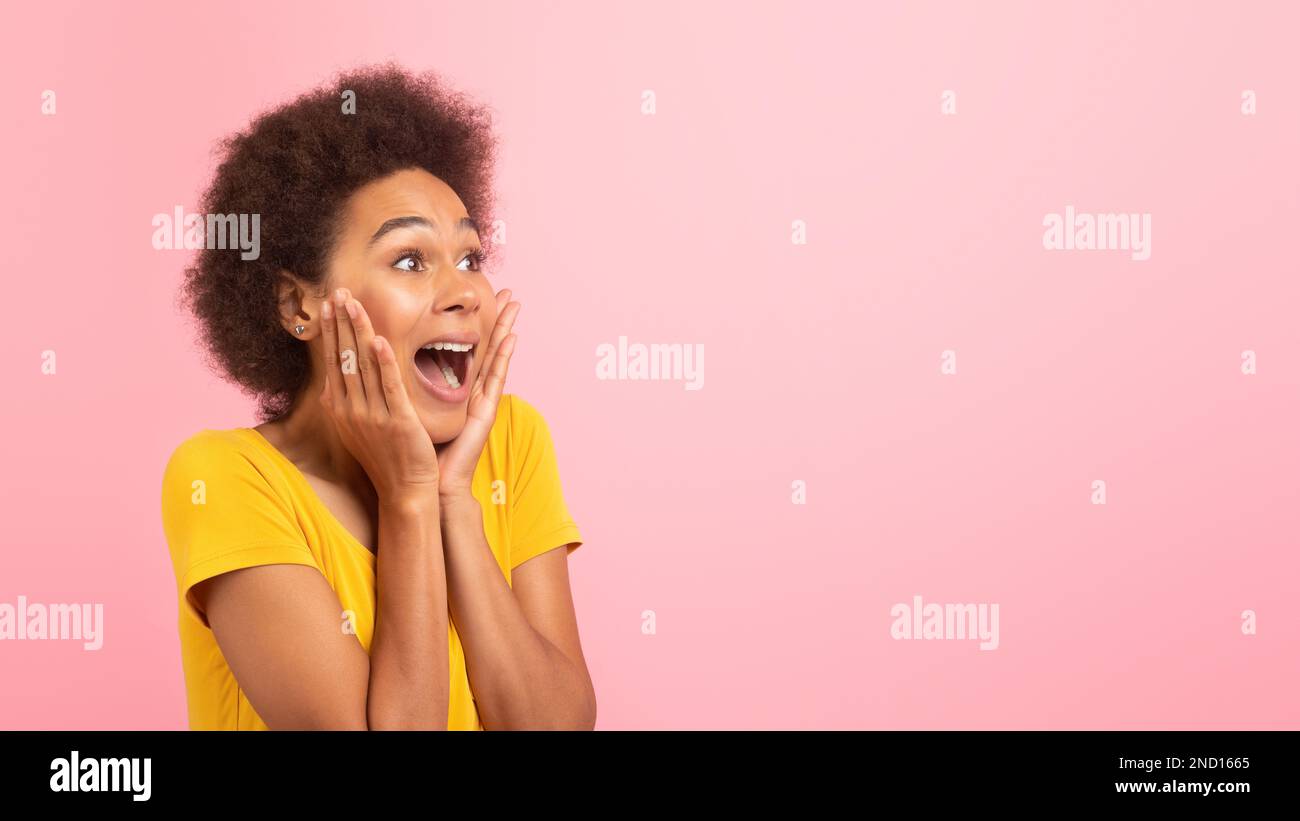 Happy shocked pretty emotional young black curly lady screaming with ...