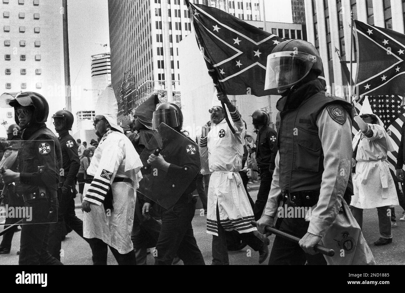 About 75 members of the Ku Klux Klan march through downtown in Houston ...