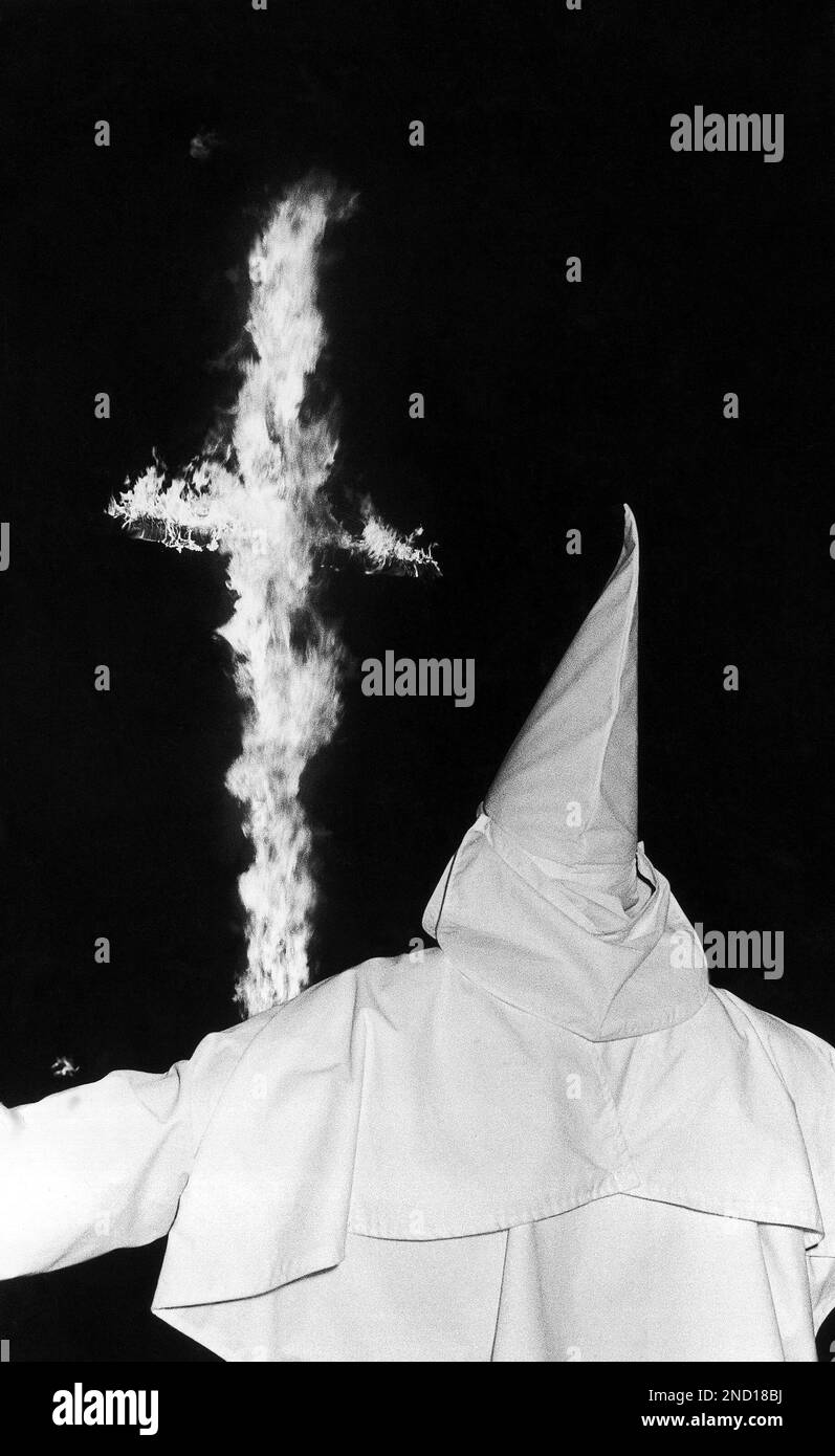 Hooded and Robed members of the Ku Klux Klan marched around a 20 foot ...
