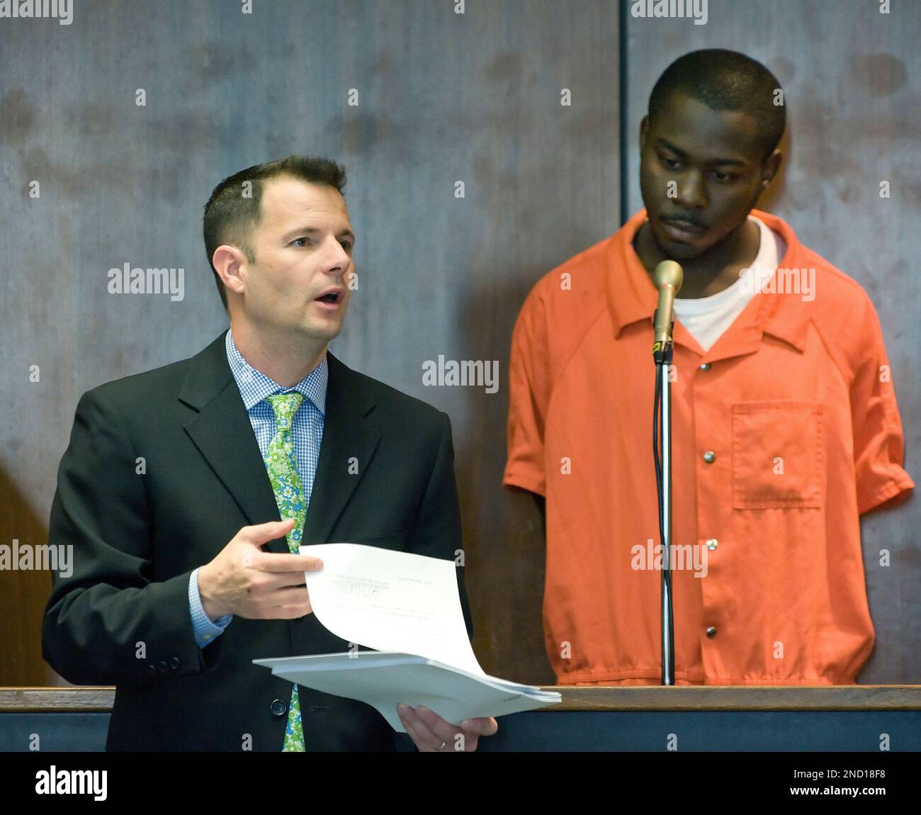 Gerald M. Saluti, left, looks over court papers as his client Nicholas ...